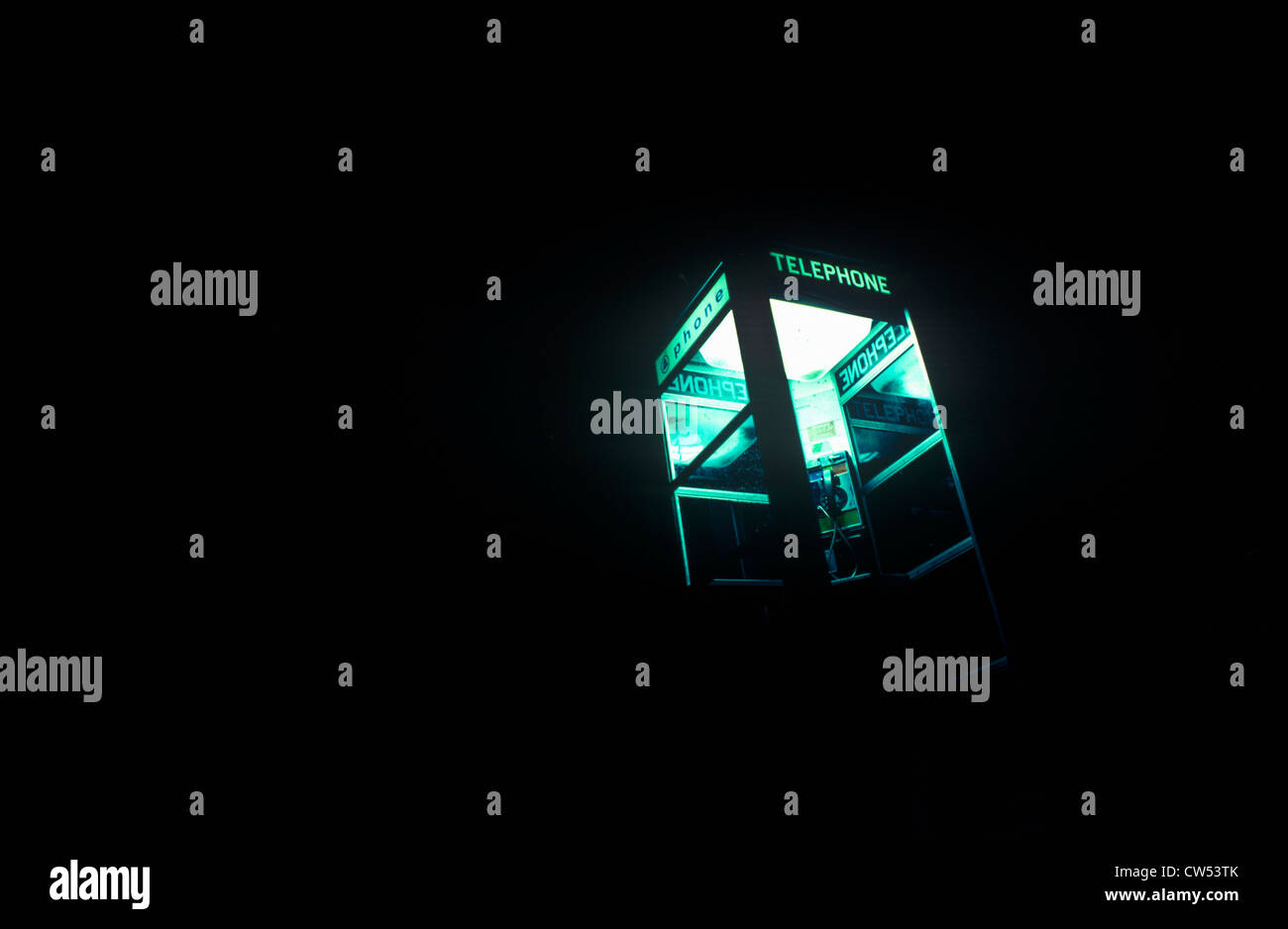 Telephone booth at night with interior lights Stock Photo - Alamy