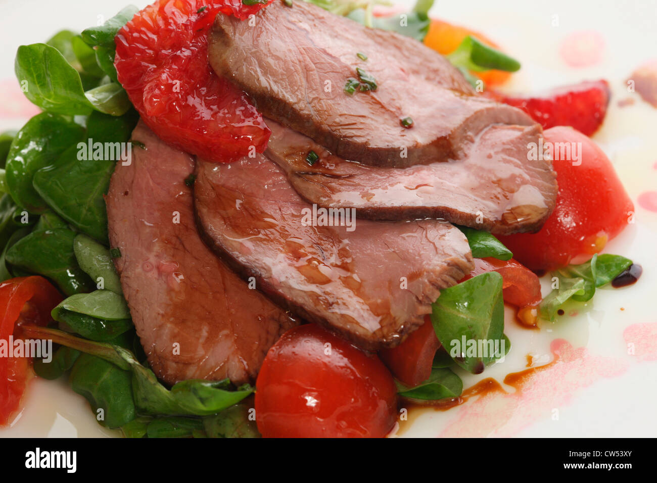 Close-up of duck meat over spinach Stock Photo - Alamy