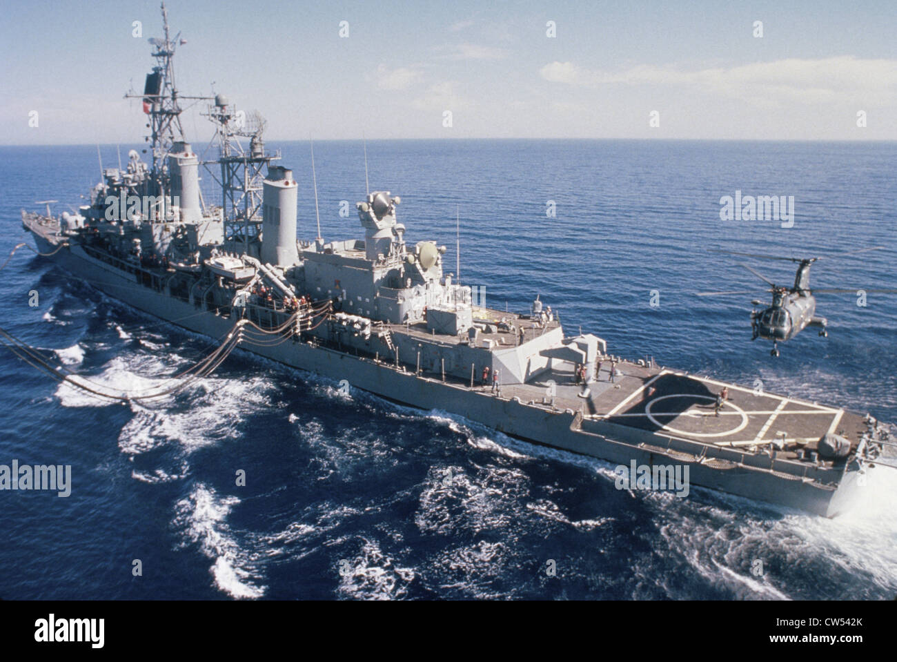 Military helicopter landing on a military ship, USS William V. Pratt ...