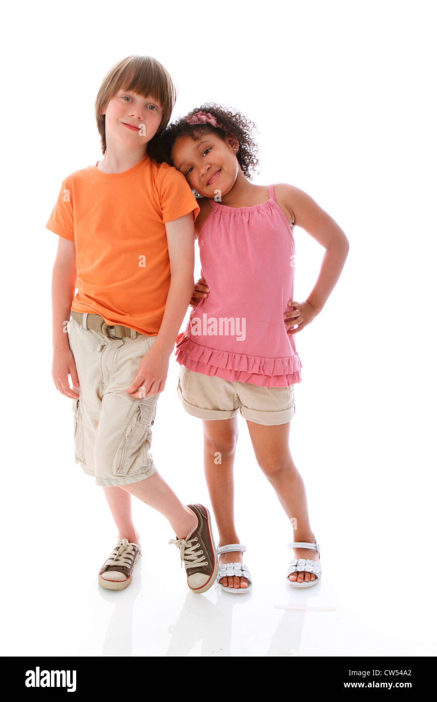 Studio shot of boy and girl standing and leaning on each other Stock ...