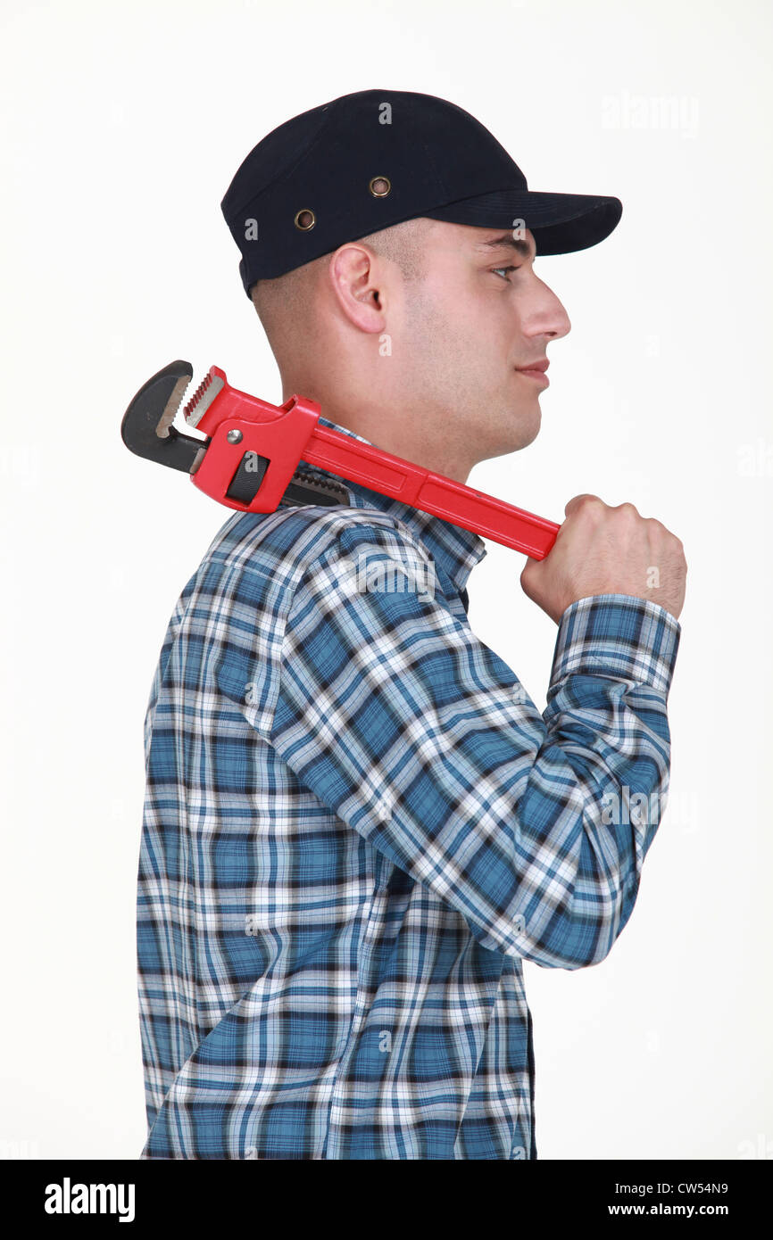 Builder carrying wrench over shoulder Stock Photo - Alamy
