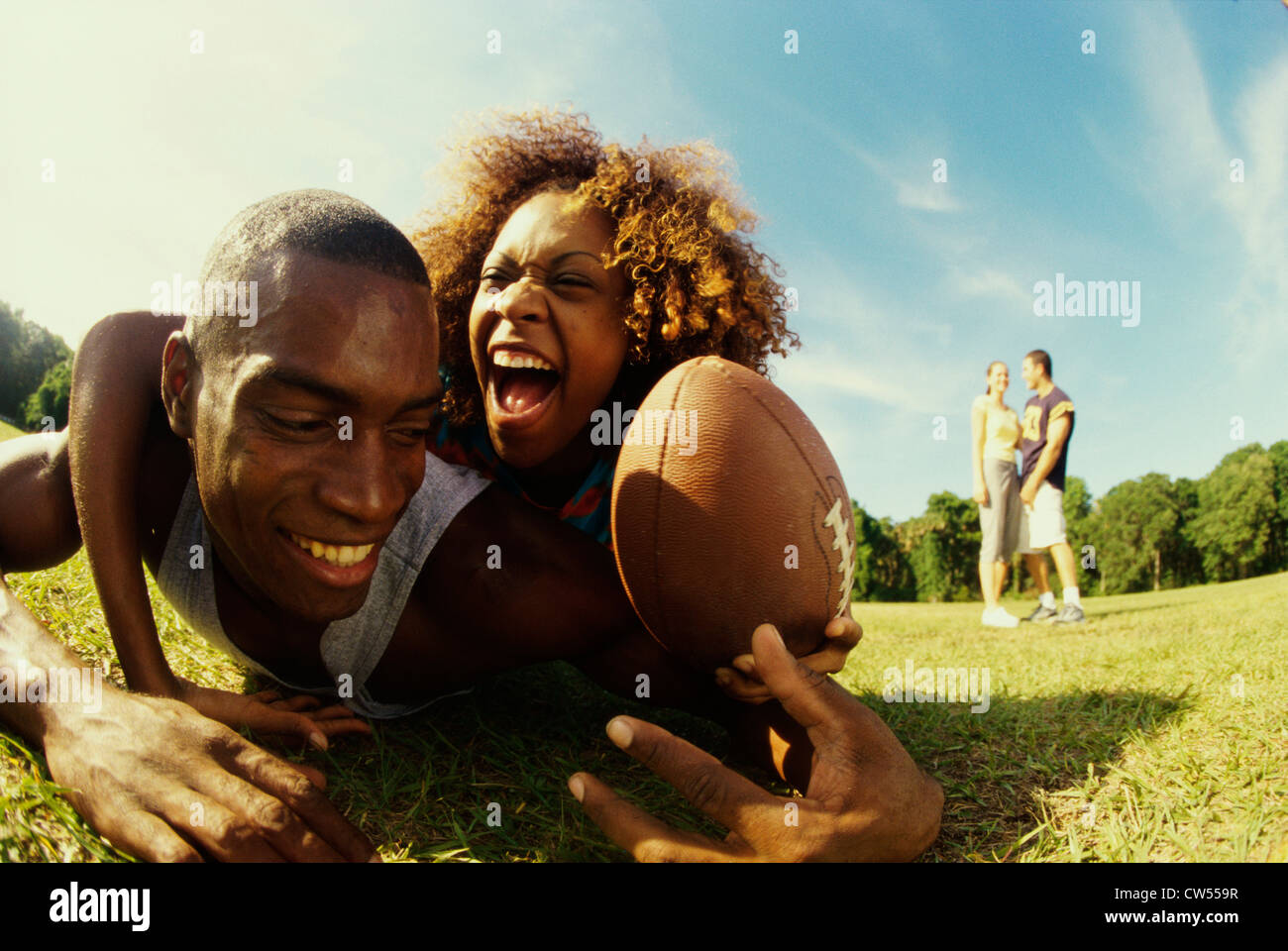 Close-up of a young couple playing football Stock Photo - Alamy