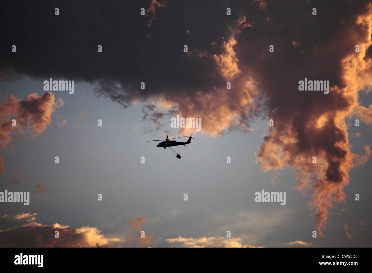 A Blackhawk helicopter with a hanging firefighting bucket for water ...
