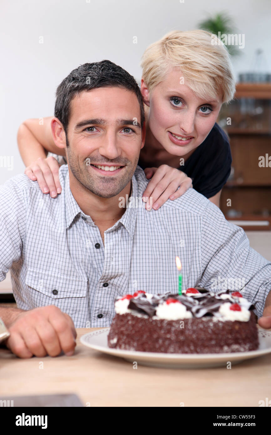 Couple with birthday cake Stock Photo - Alamy