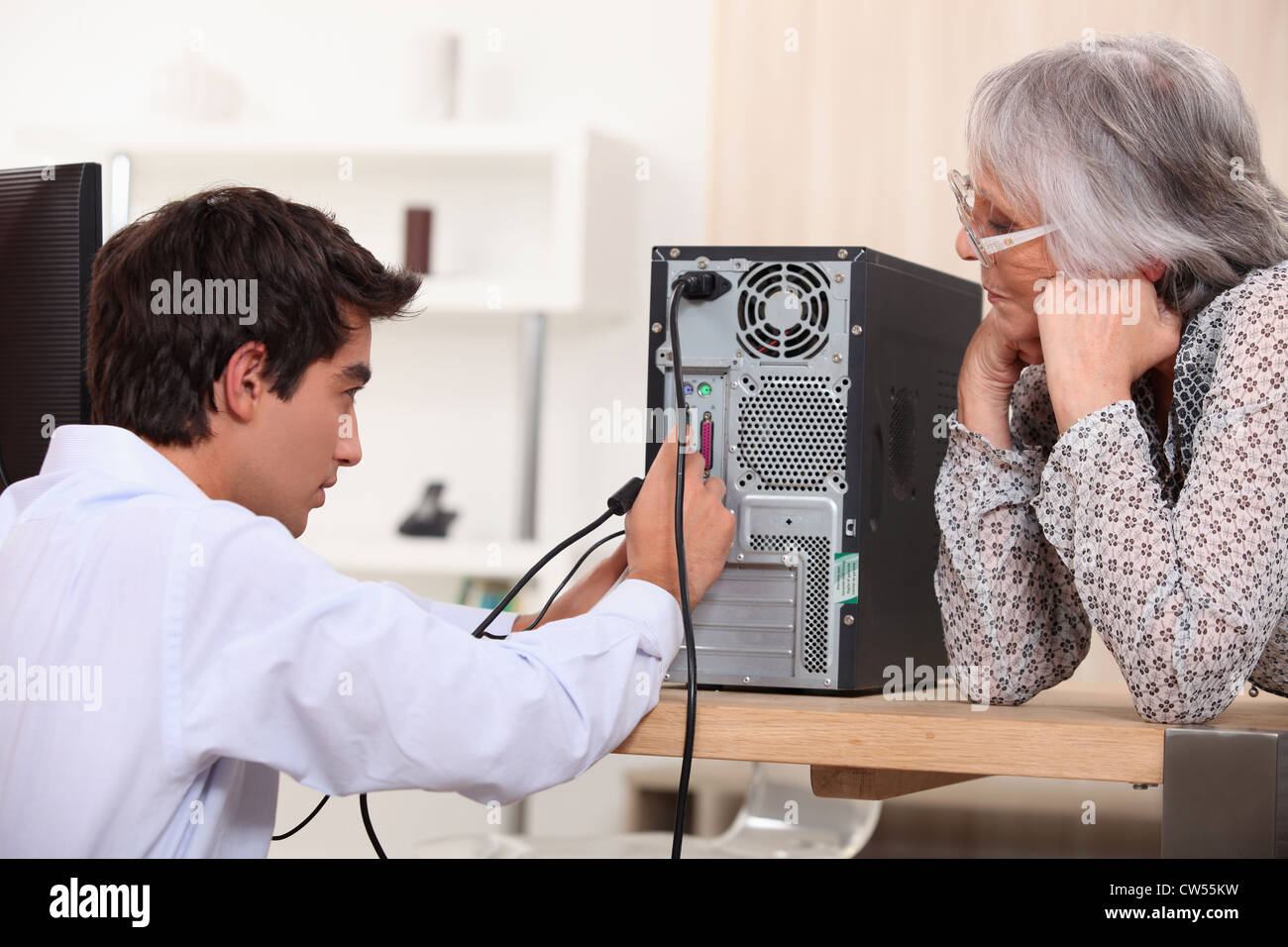 Young installing computer Stock Photo - Alamy