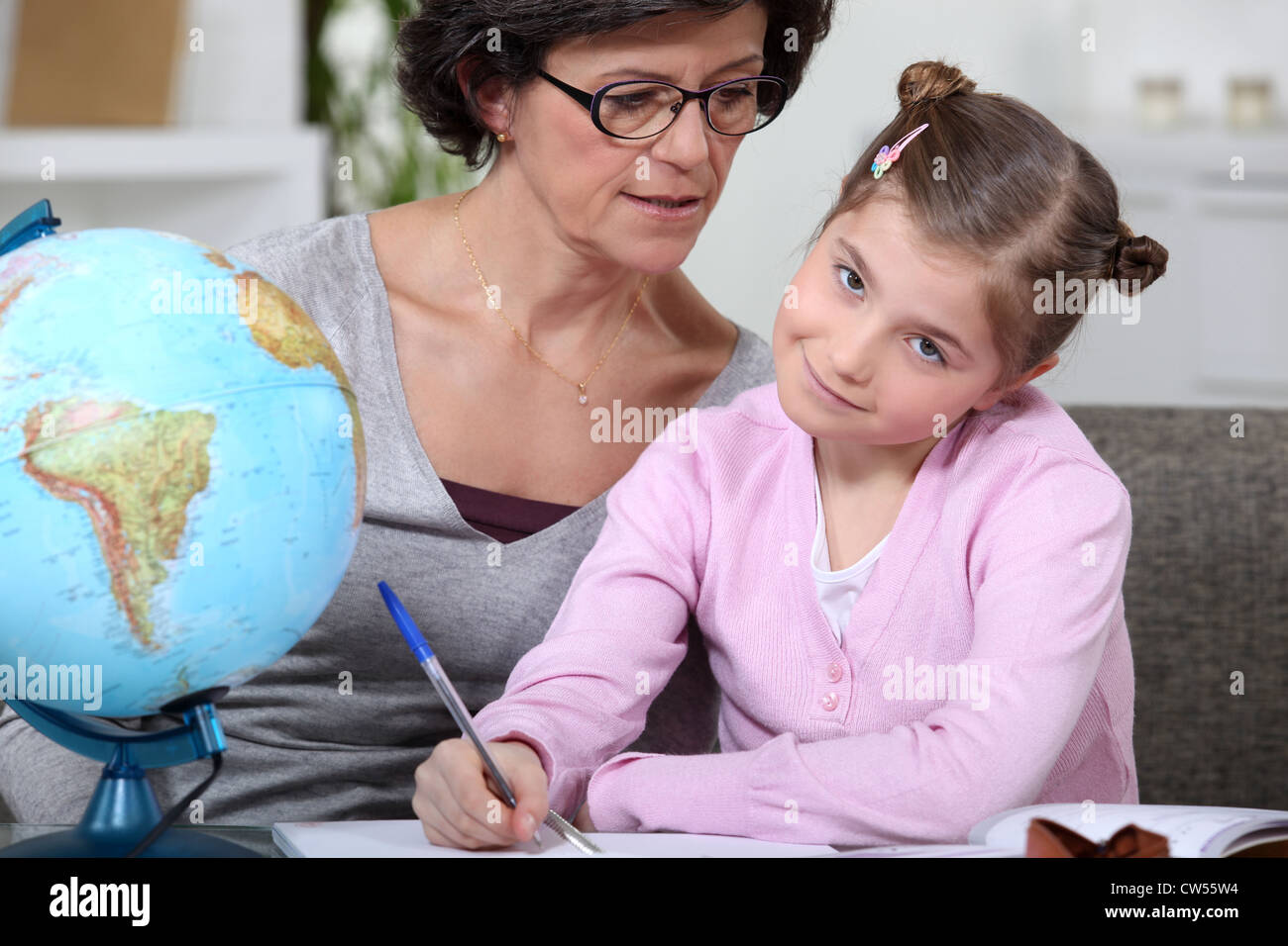 Mother helping her daughter with her homework Stock Photo - Alamy