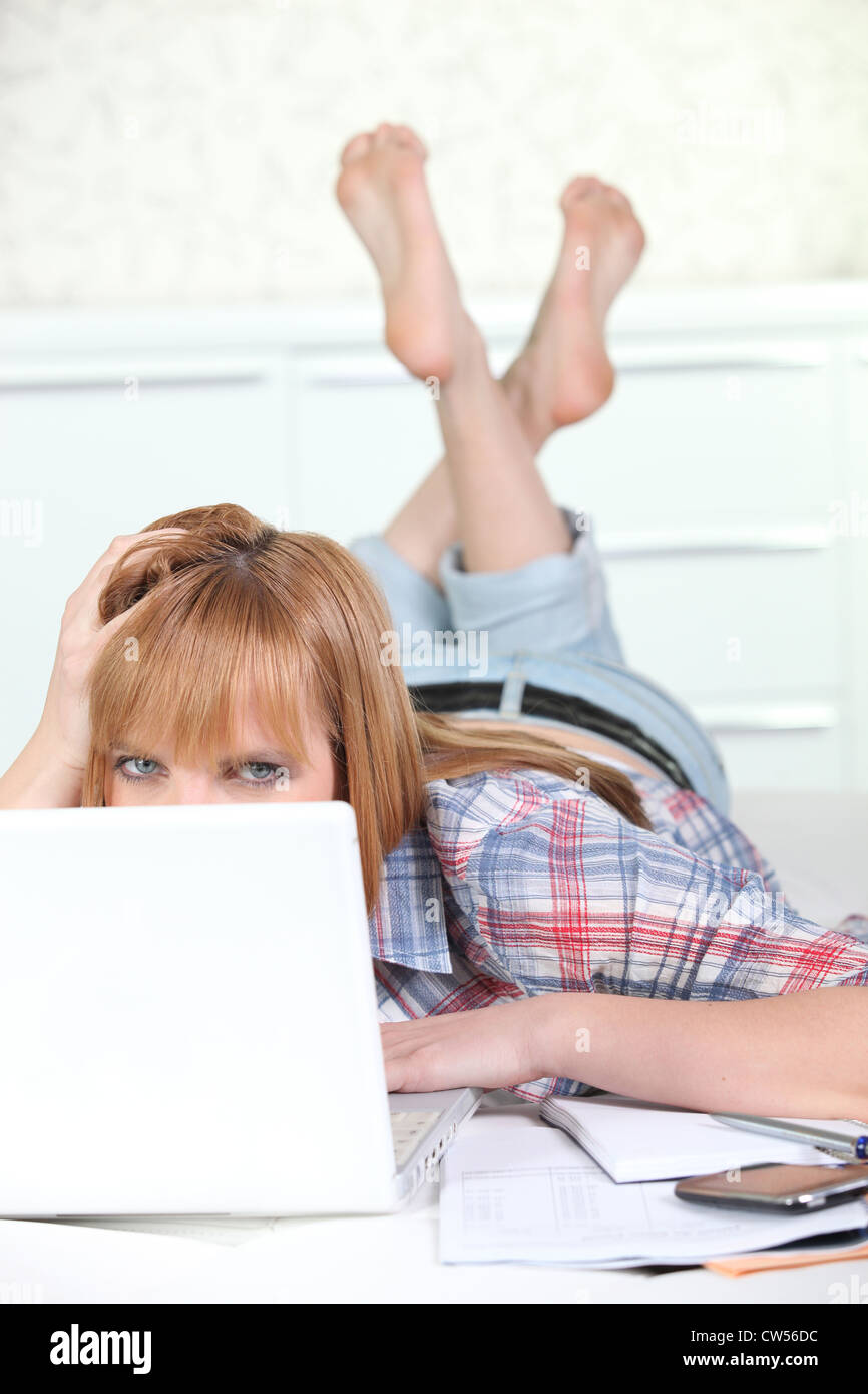 Young woman laid in front of computer Stock Photo - Alamy