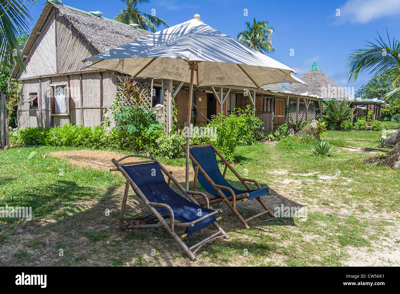 Coastal straw house with deck chairs and parasol in Sainte-Marie island ...