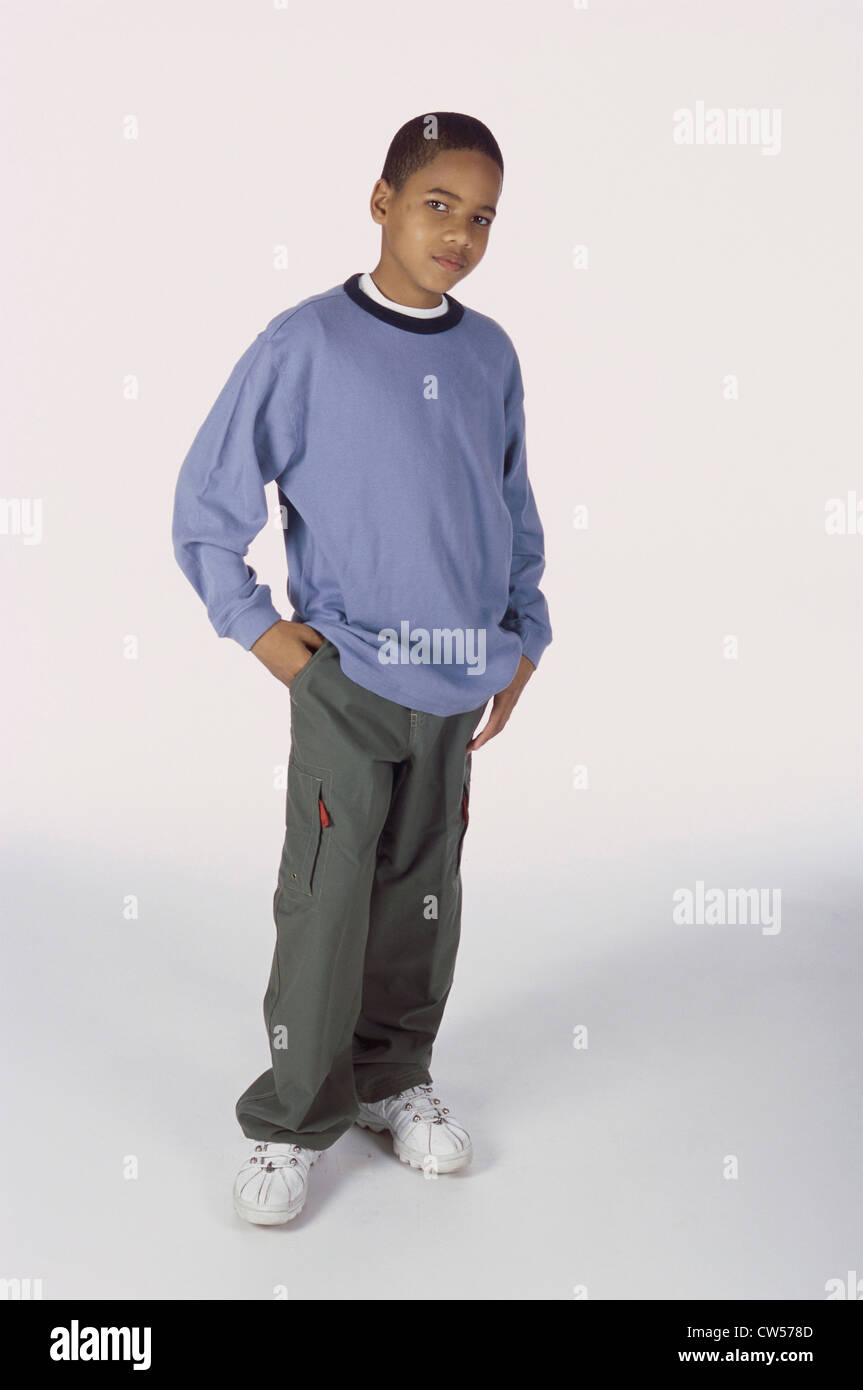 Portrait of a boy standing with his hands in his pockets Stock Photo ...