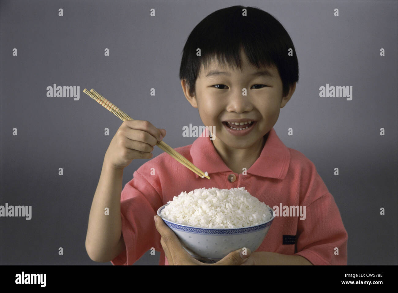 Child with a bowl of rice hi-res stock photography and images - Alamy