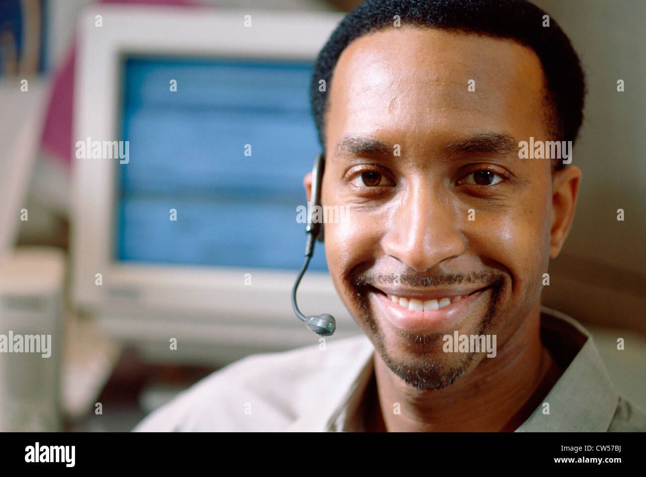 Portrait of a customer service representative wearing a headset smiling ...