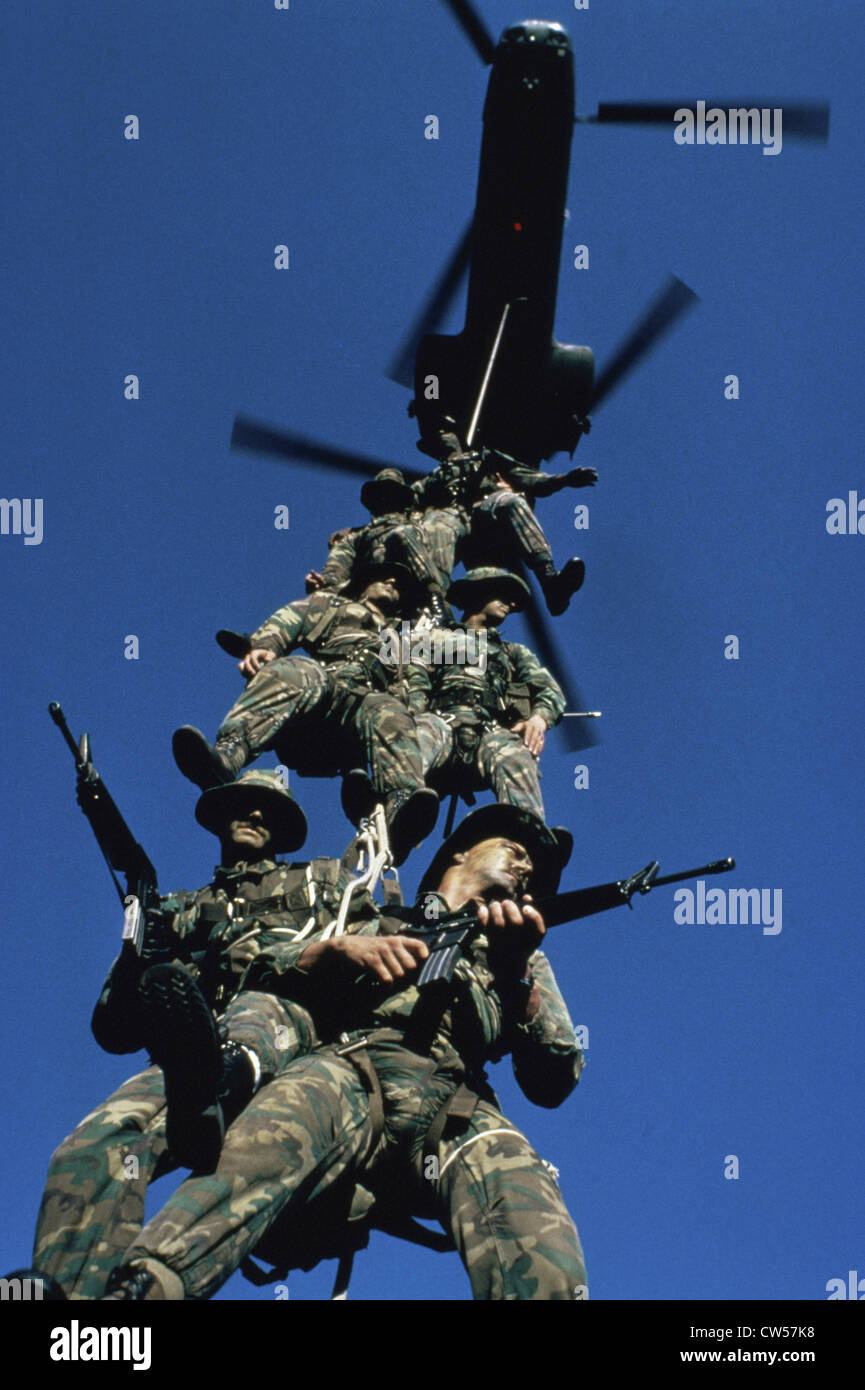 Low angle view of soldiers being airlifted by a military helicopter ...