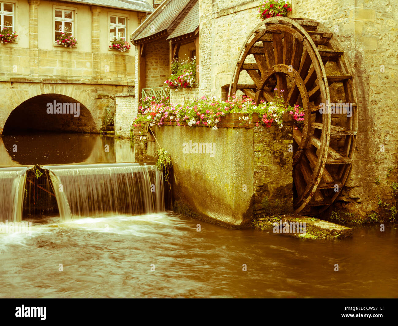 A water wheel at an historic medieval mill on the Aure River, which ...