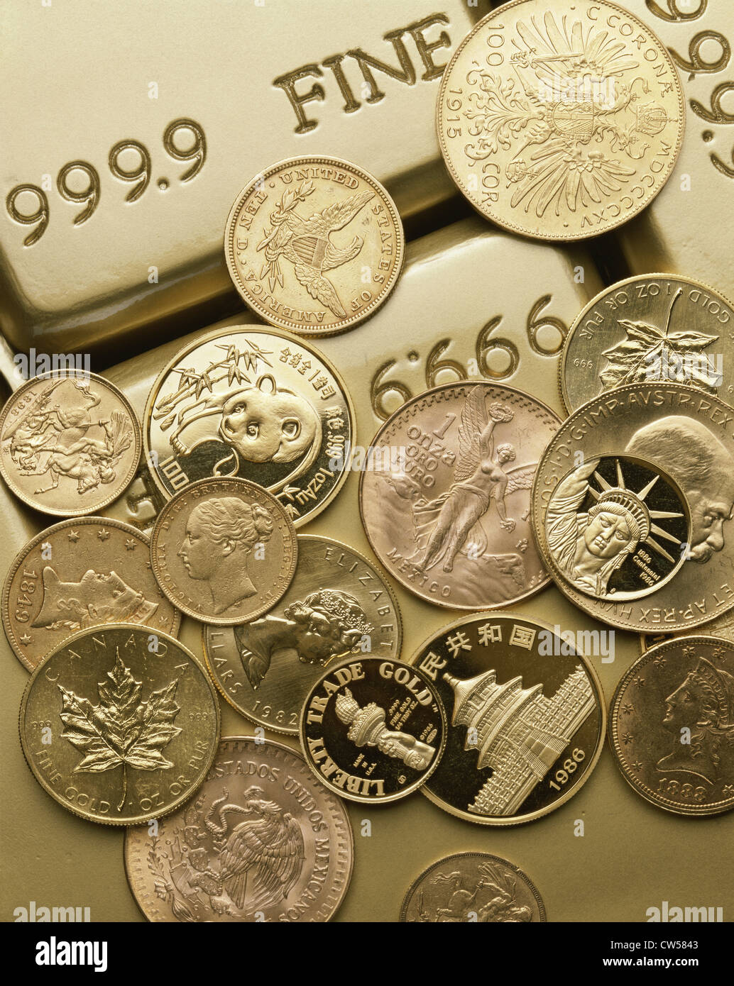 High angle view of gold ingots with gold coins Stock Photo - Alamy