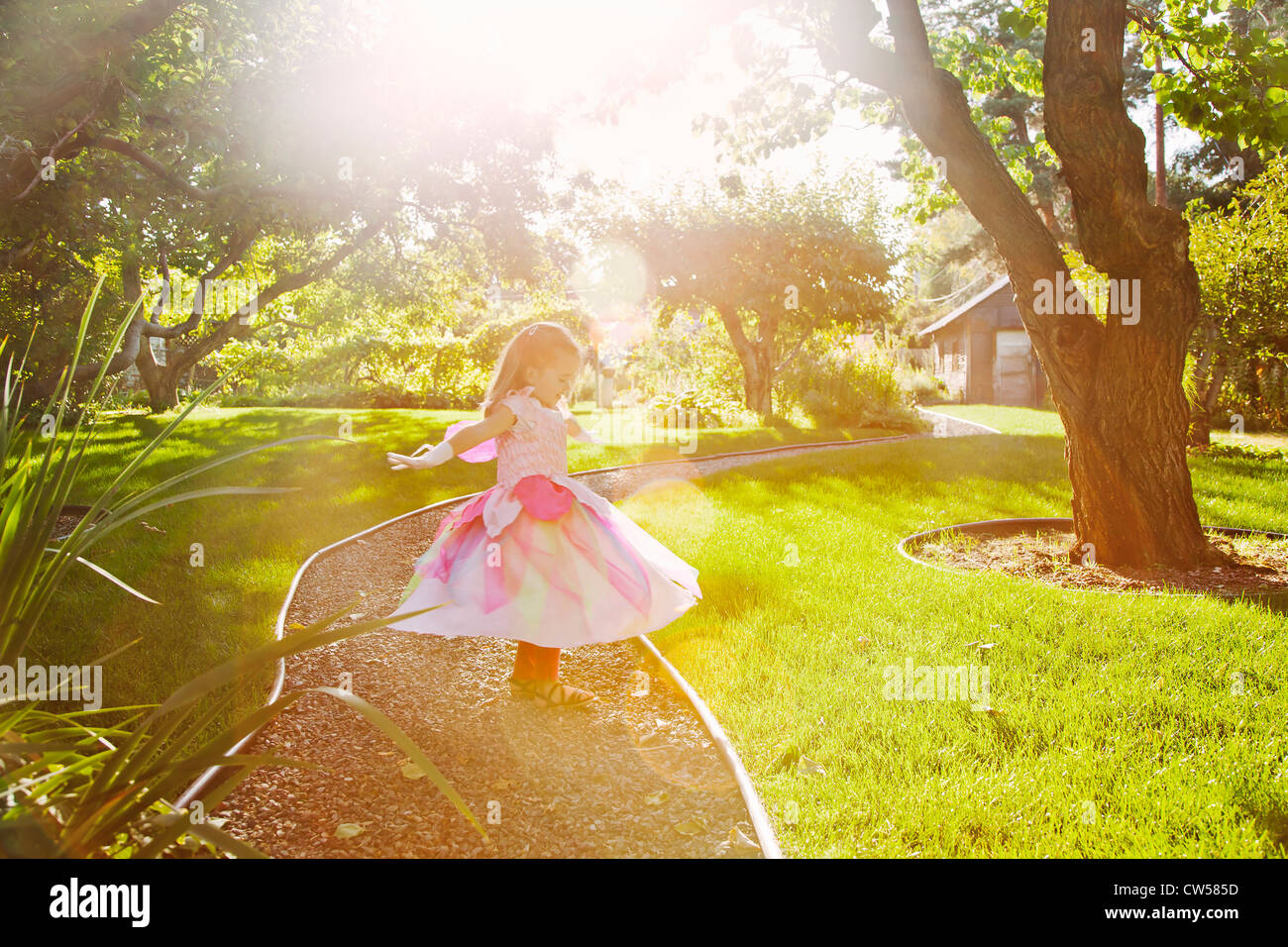 Girl in princess outfit walking on path in sunlight Stock Photo - Alamy