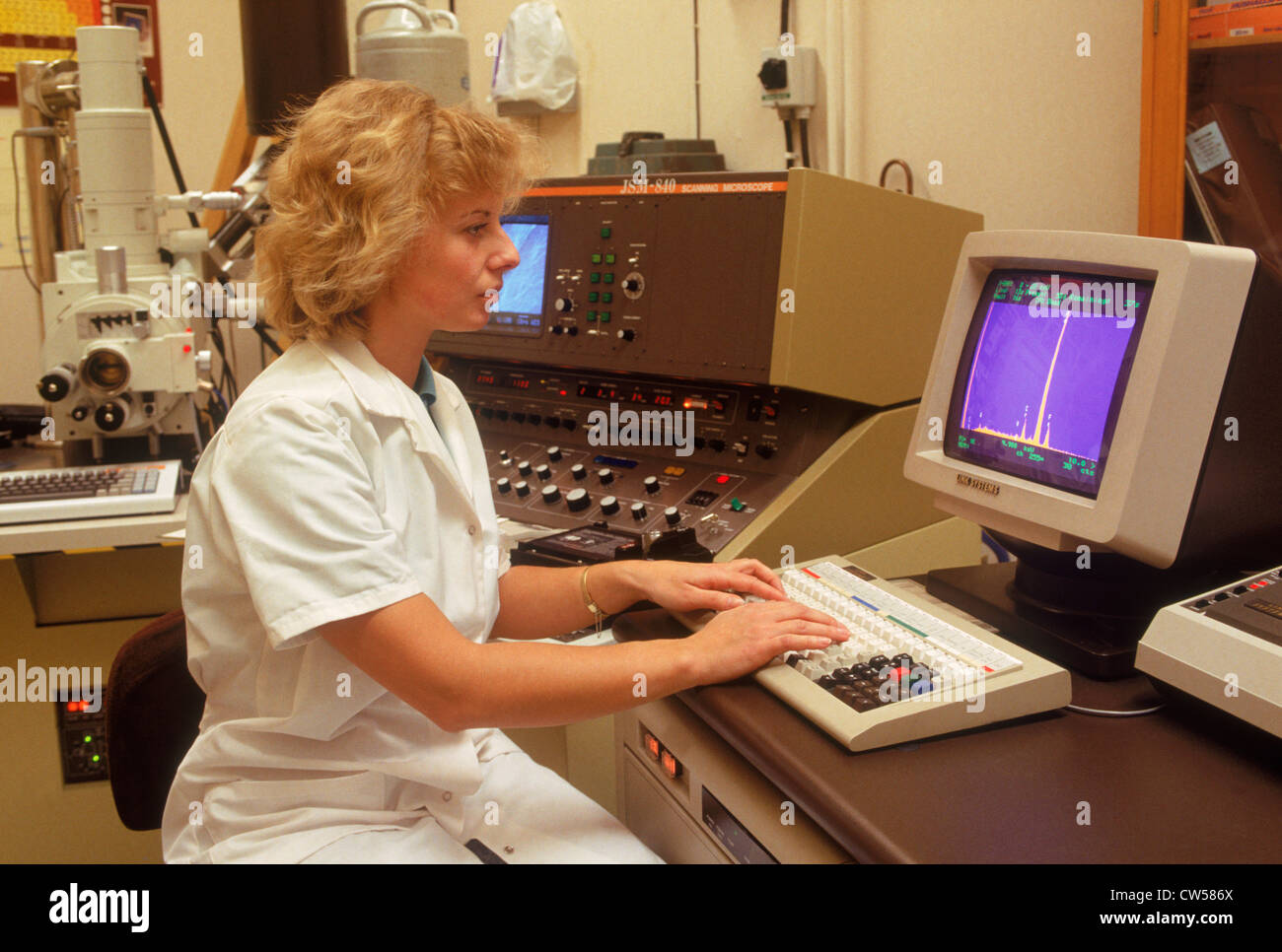 Woman in research lab with scanning electron microscope and x ray ...