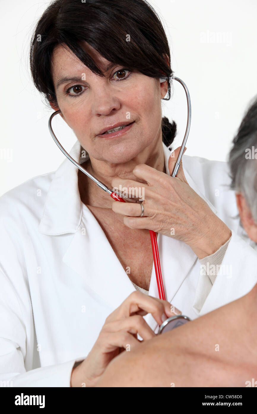 Female doctor checking her patient Stock Photo - Alamy