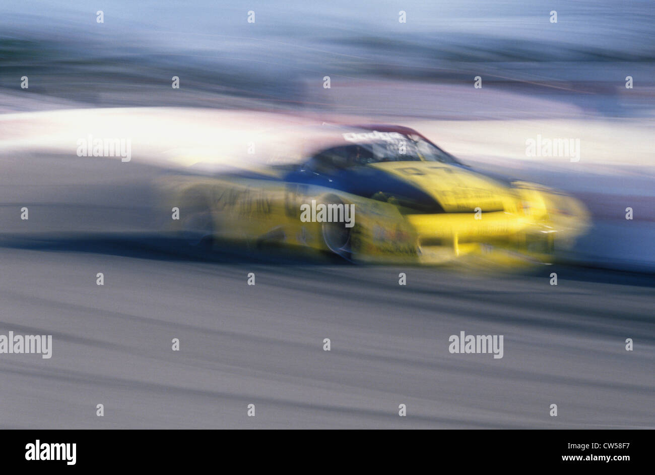 A yellow car in the Toyota Grand Prix Race at the Indy Car World Series ...