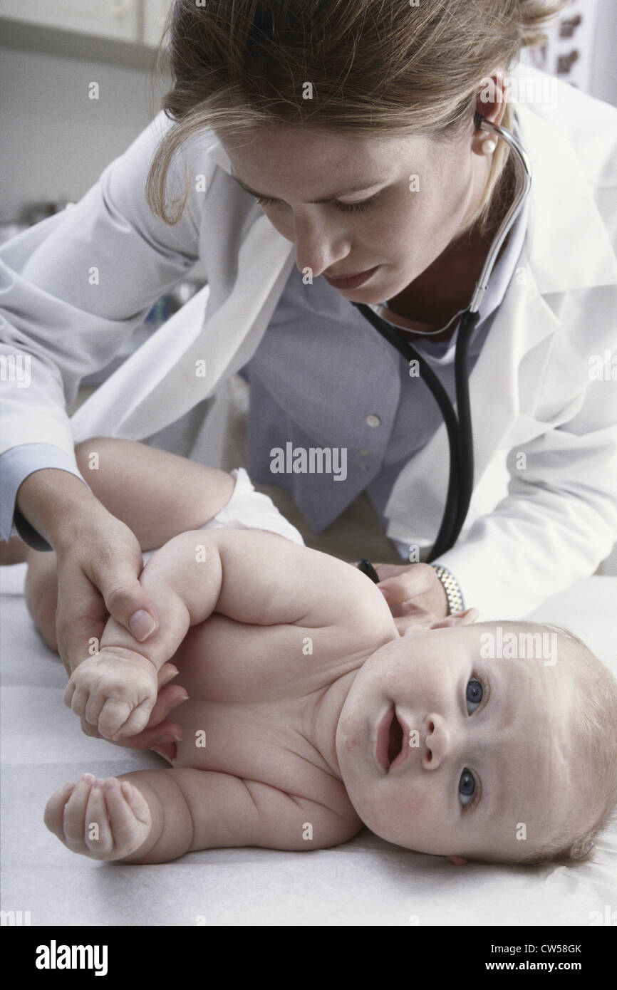 Female doctor examining a baby boy Stock Photo - Alamy