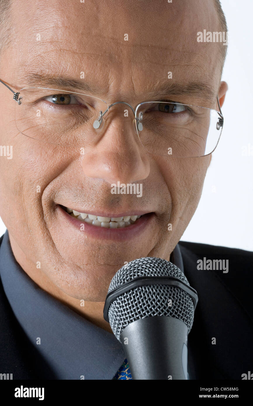 Portrait of a businessman speaking into a microphone Stock Photo - Alamy