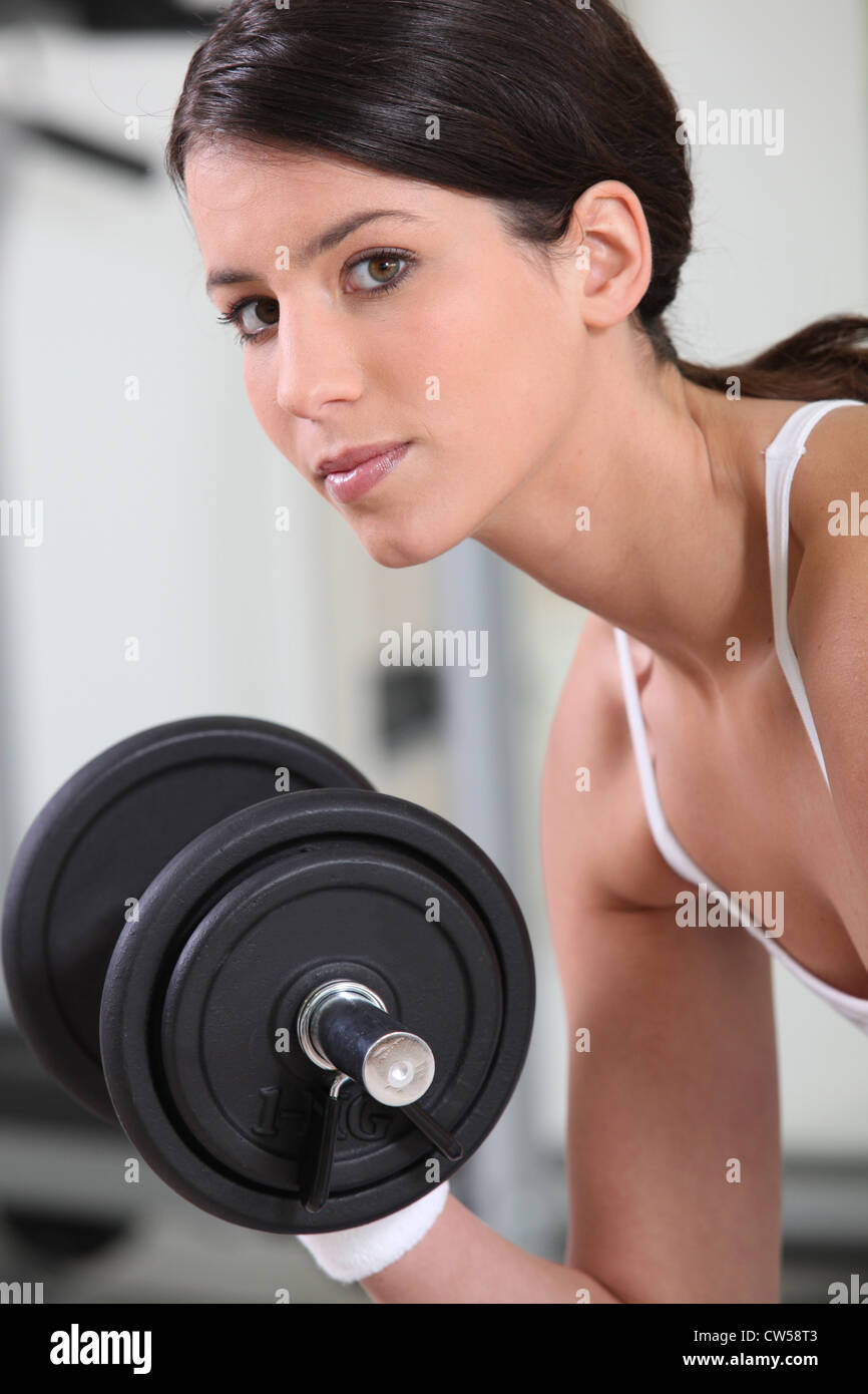 Woman lifting a dumbbell Stock Photo - Alamy