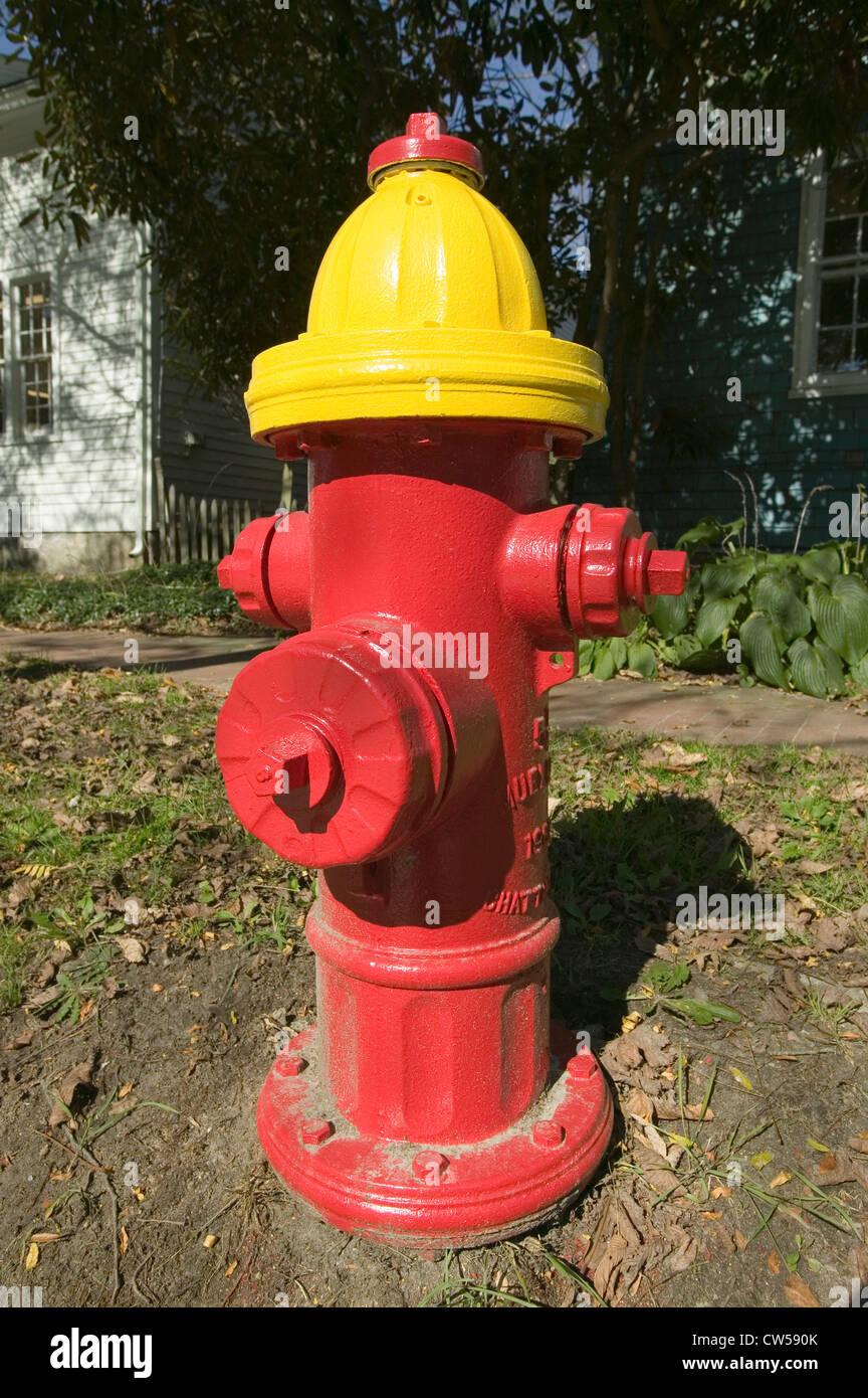 A red fire hydrant with a yellow top is seen roadside in New England ...