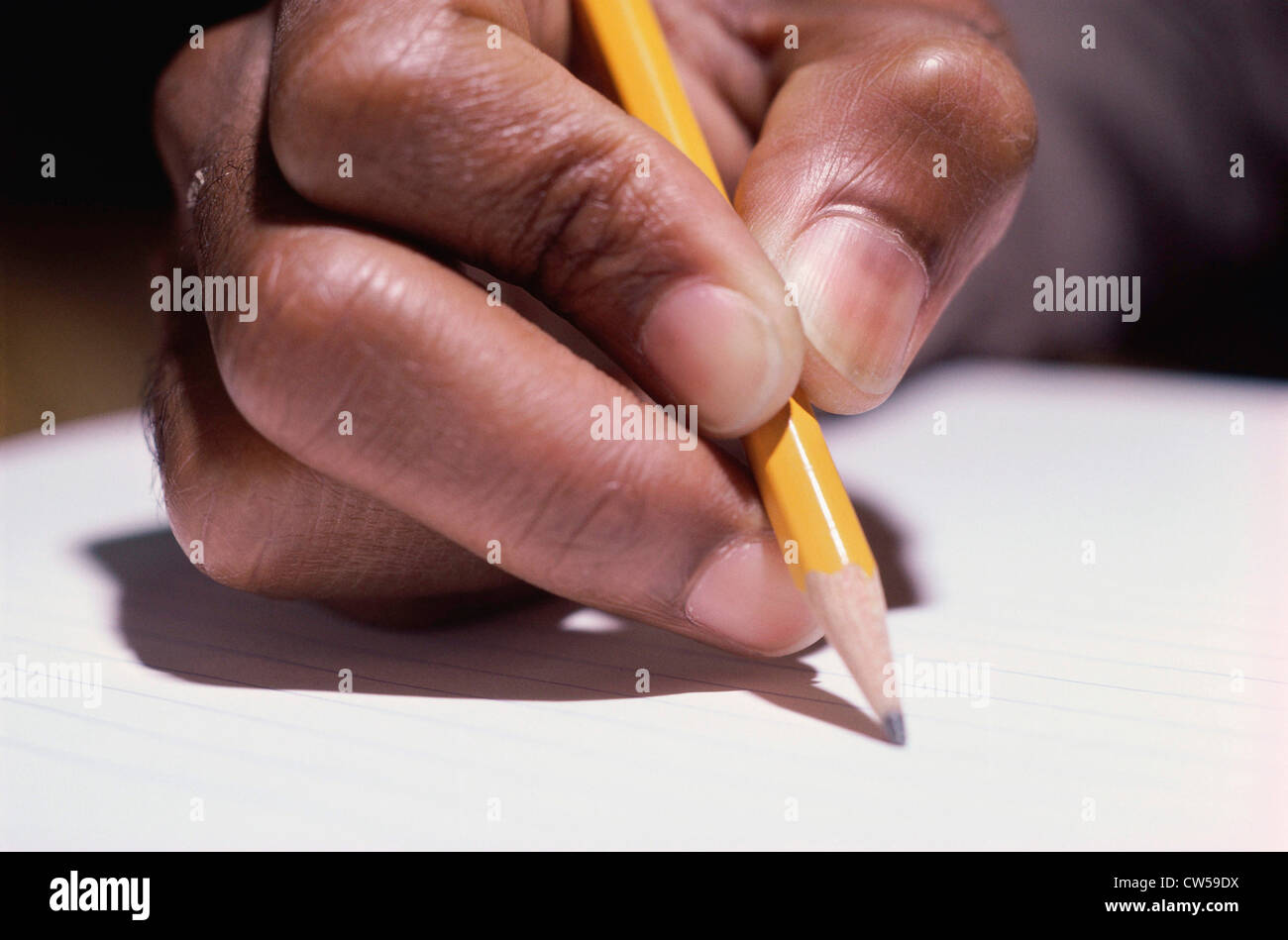 Close-up of a person's hand writing on a notepad Stock Photo - Alamy