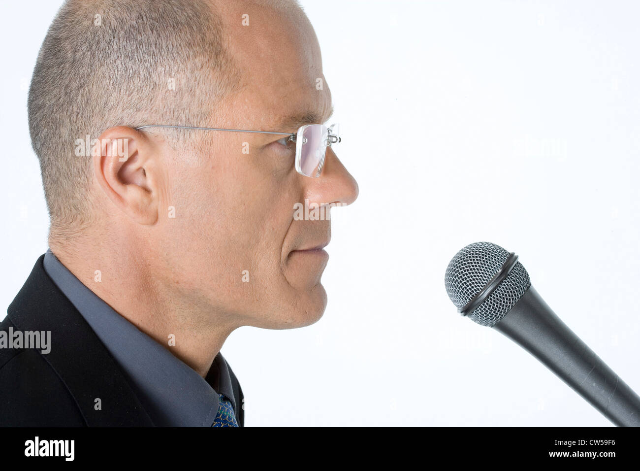 Close-up of a businessman speaking into a microphone Stock Photo - Alamy