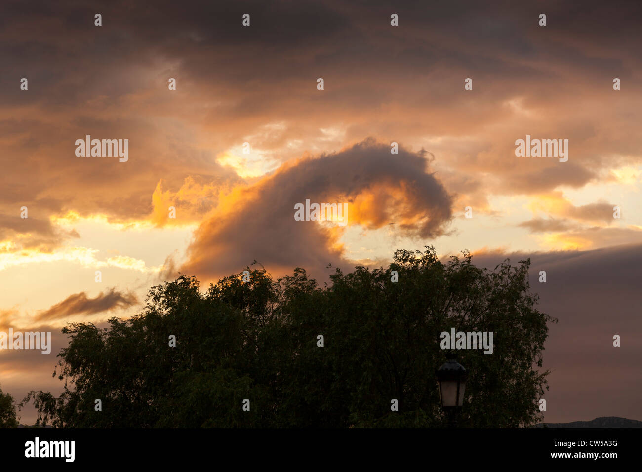 Unusual wave like cloud formation with beautiful colours in setting sun ...