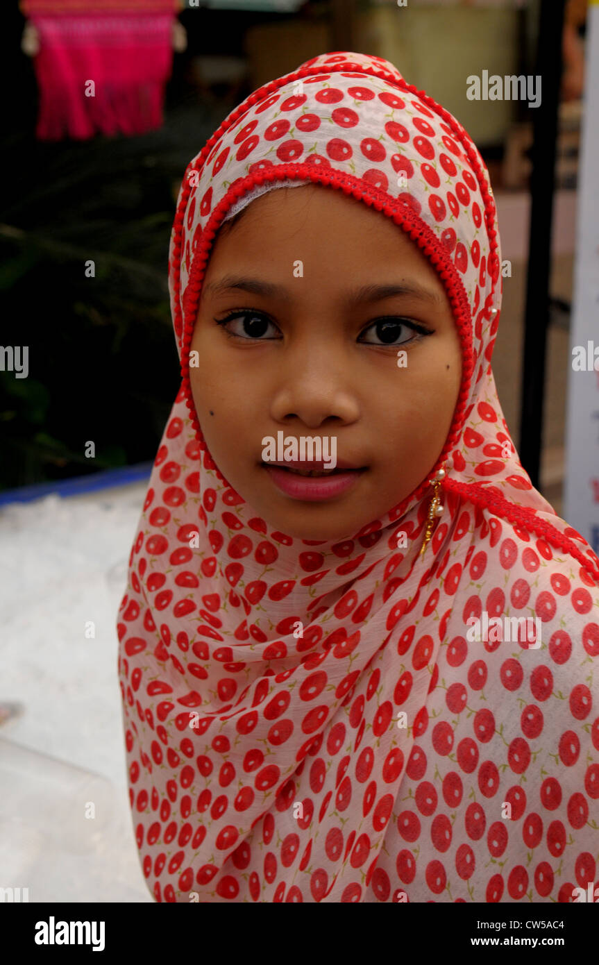 muslim girl in traditional dress and headscarf during mosque festival ...
