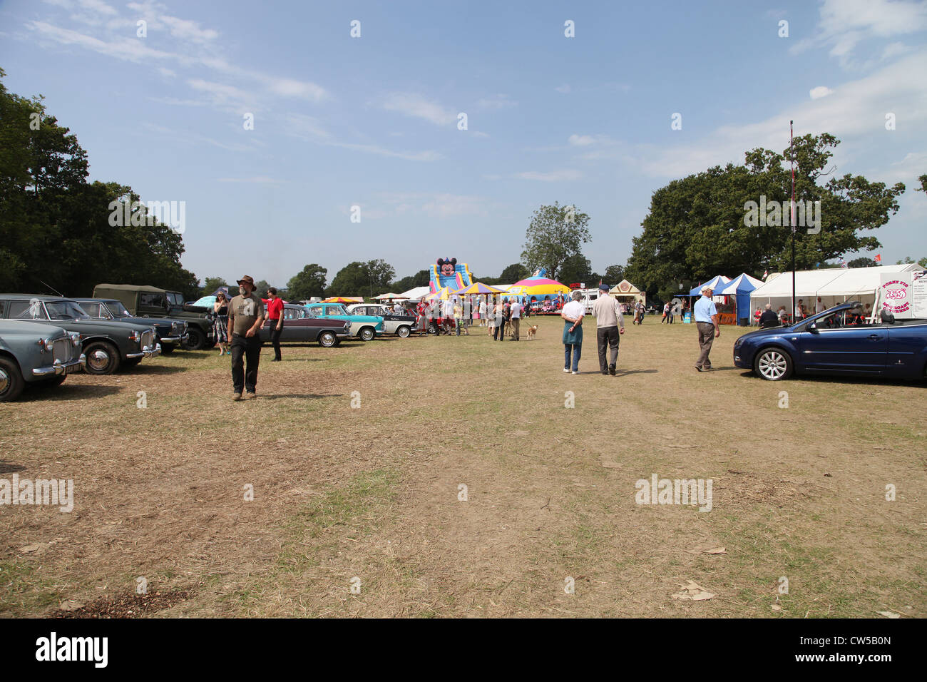 View of a vehicle and country show with fairground rides and classic ...