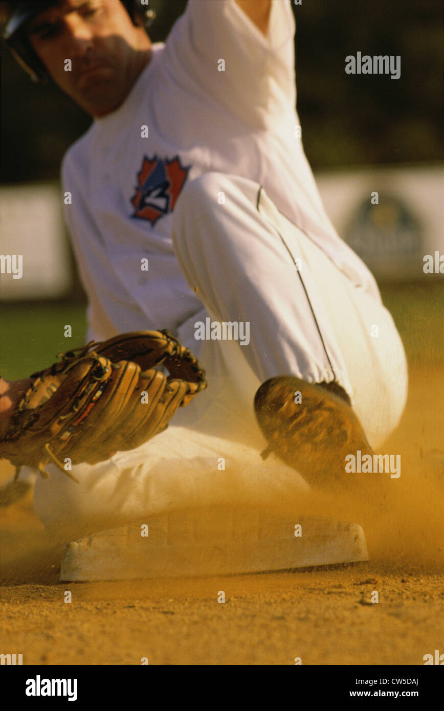 Baseball player sliding into a base Stock Photo - Alamy