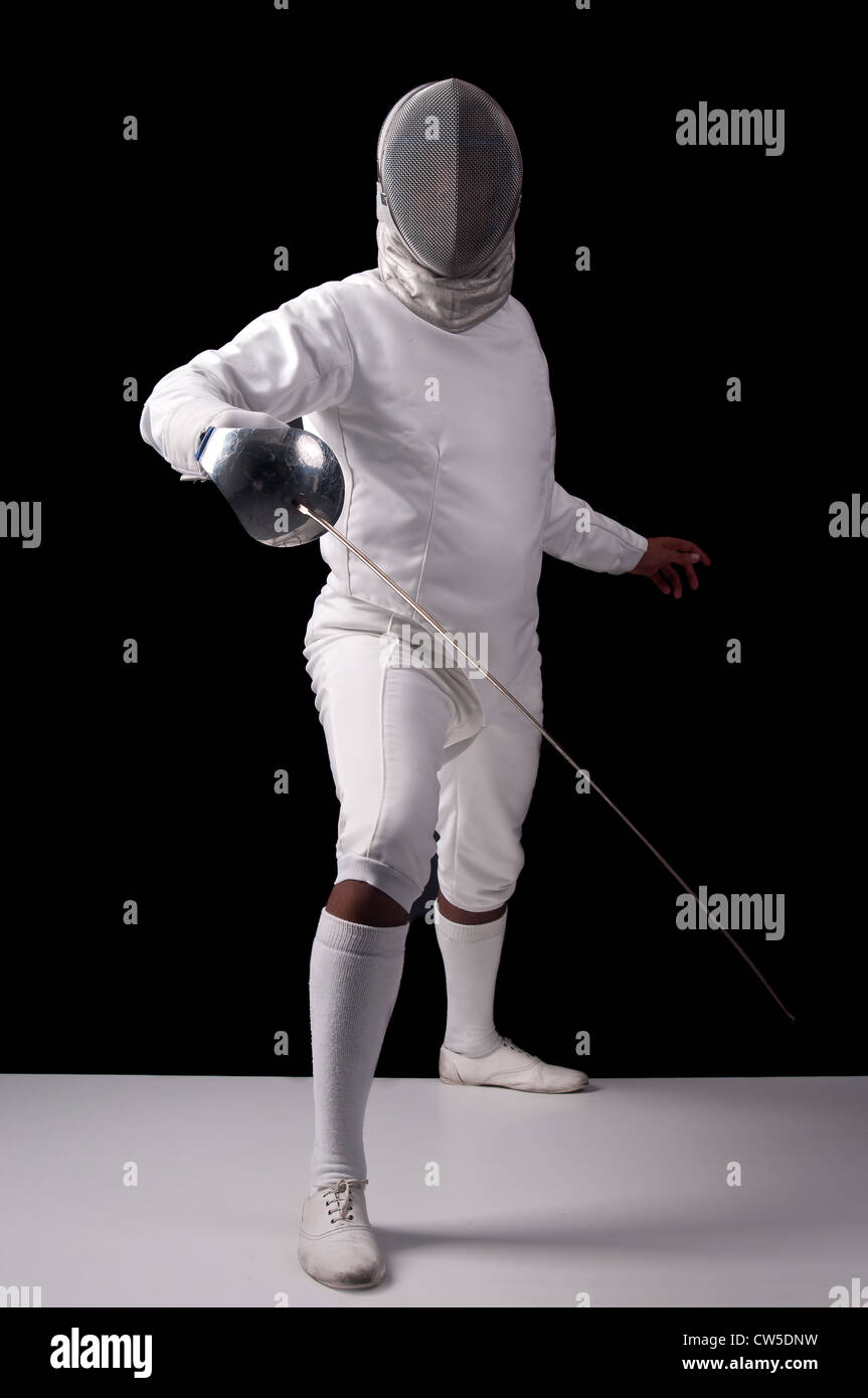 Male fencer isolated in a dark background Stock Photo - Alamy