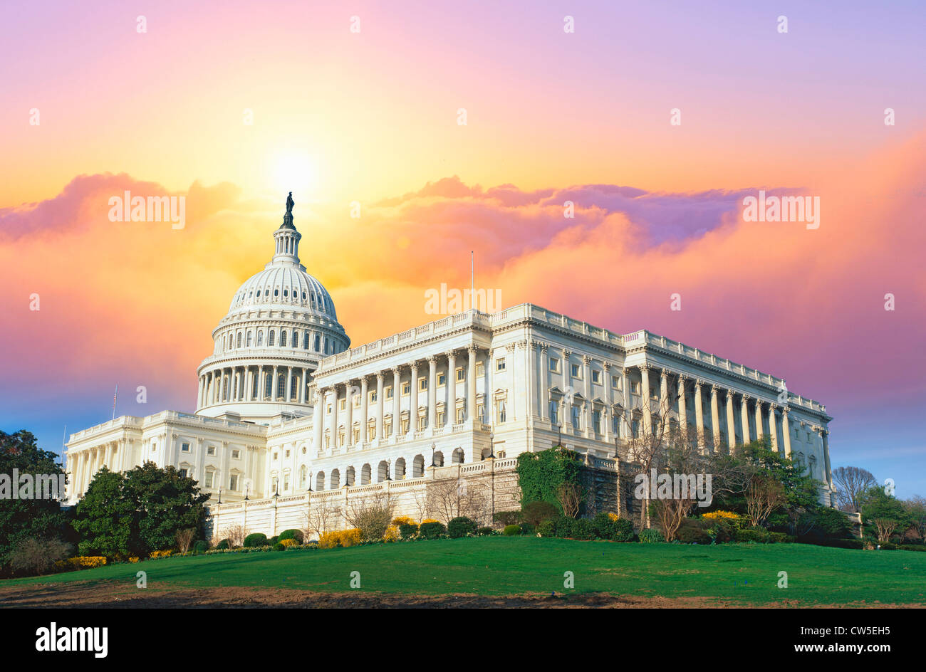 Composite image of the U.S. Capitol and blue sky with sunset behind the ...