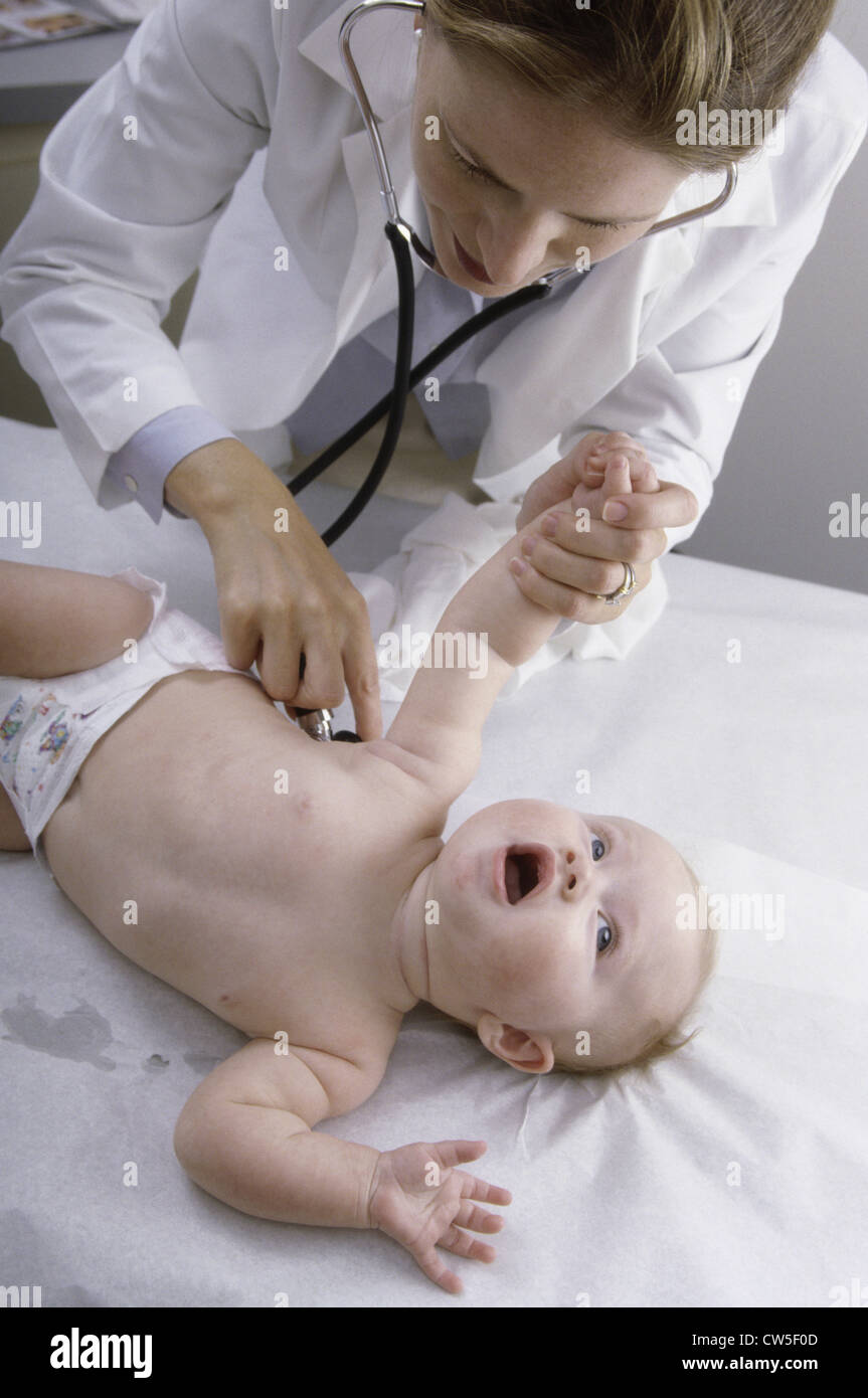 Female doctor examining a baby boy Stock Photo - Alamy