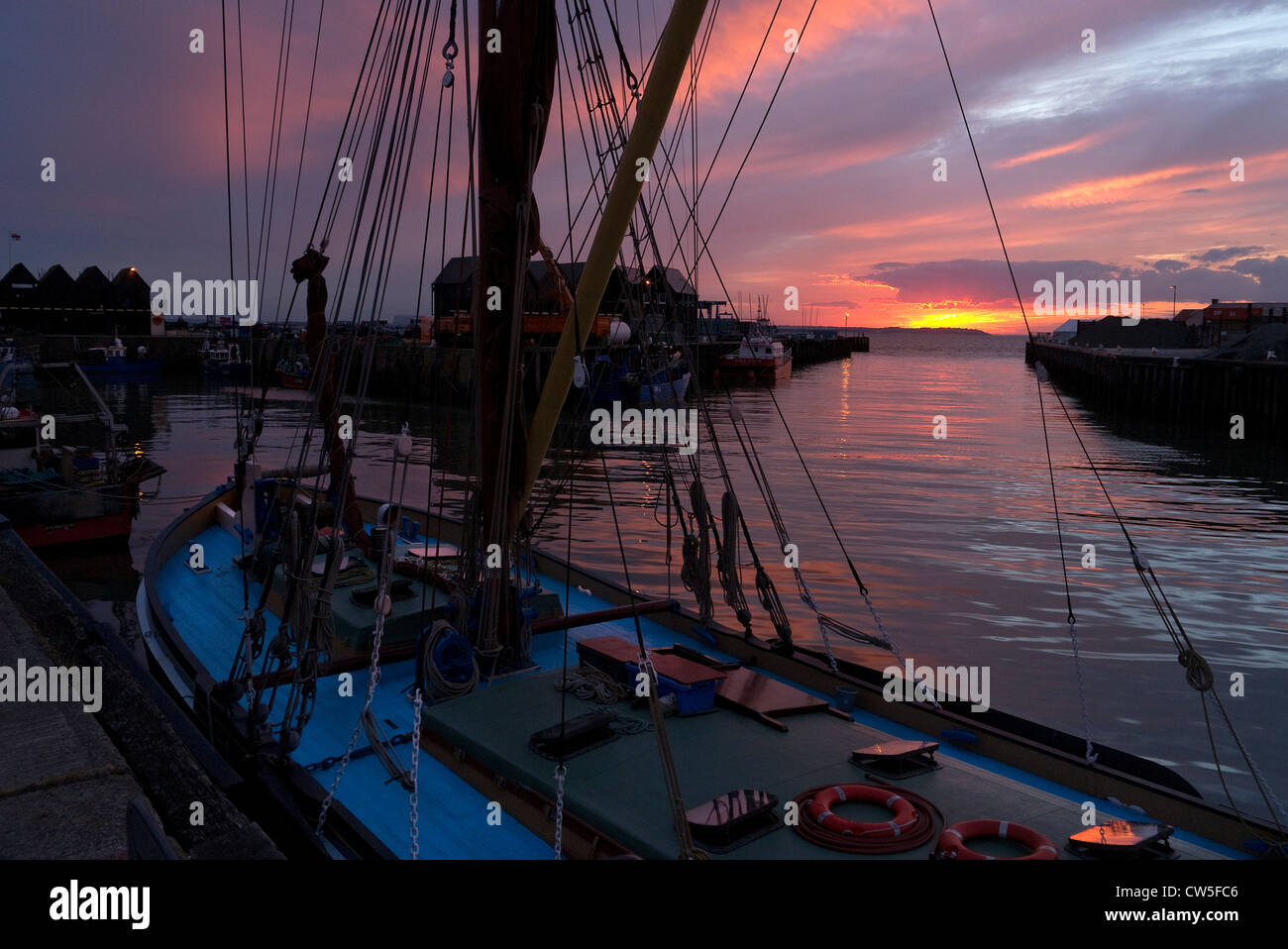 Thames barge moored in Whitstable harbour Kent UK at sunset Stock Photo - Alamy
