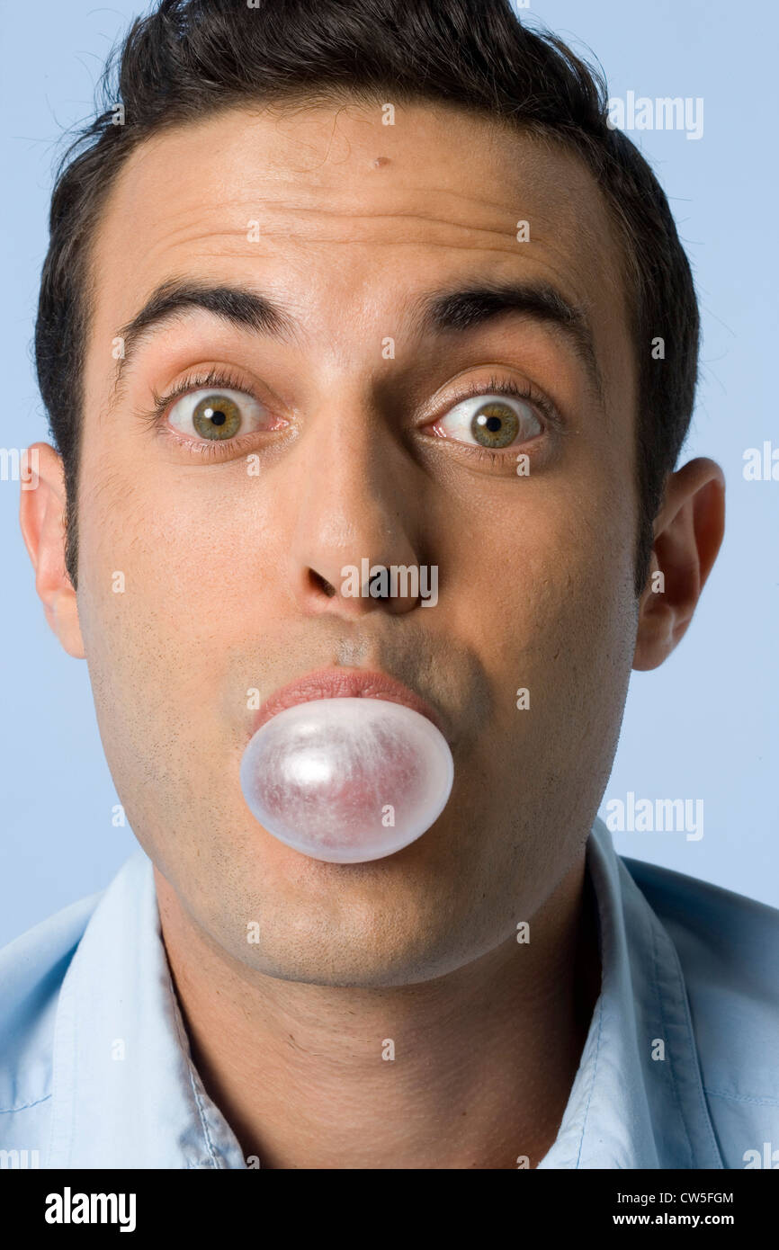 Portrait of a young man blowing a bubble Stock Photo - Alamy
