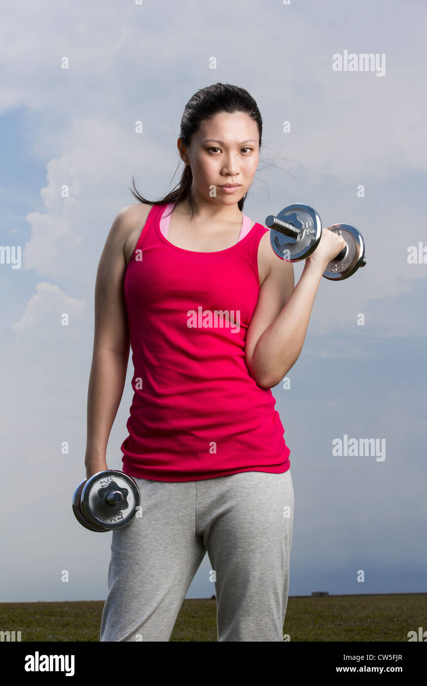 Girl training blue dumbbell hi-res stock photography and images - Alamy