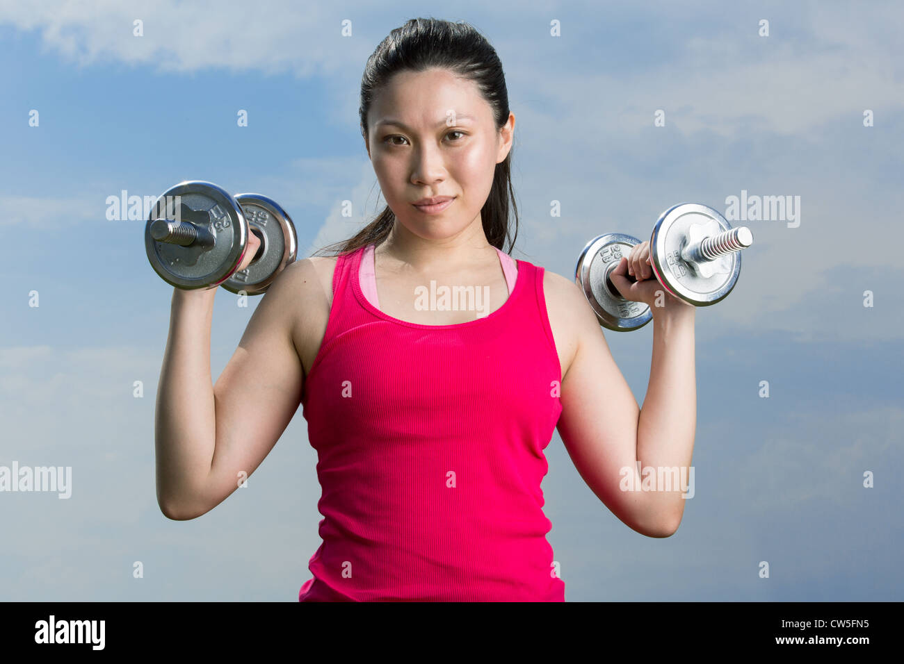 Chinese woman exercising with dumbbells Stock Photo - Alamy
