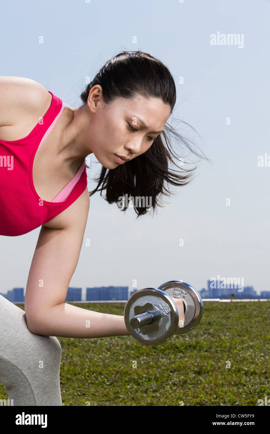 Chinese woman exercising with dumbbells Stock Photo - Alamy