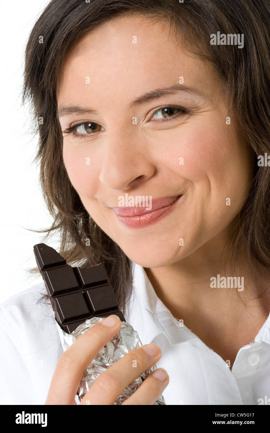 Close-up of a young woman eating chocolate Stock Photo - Alamy