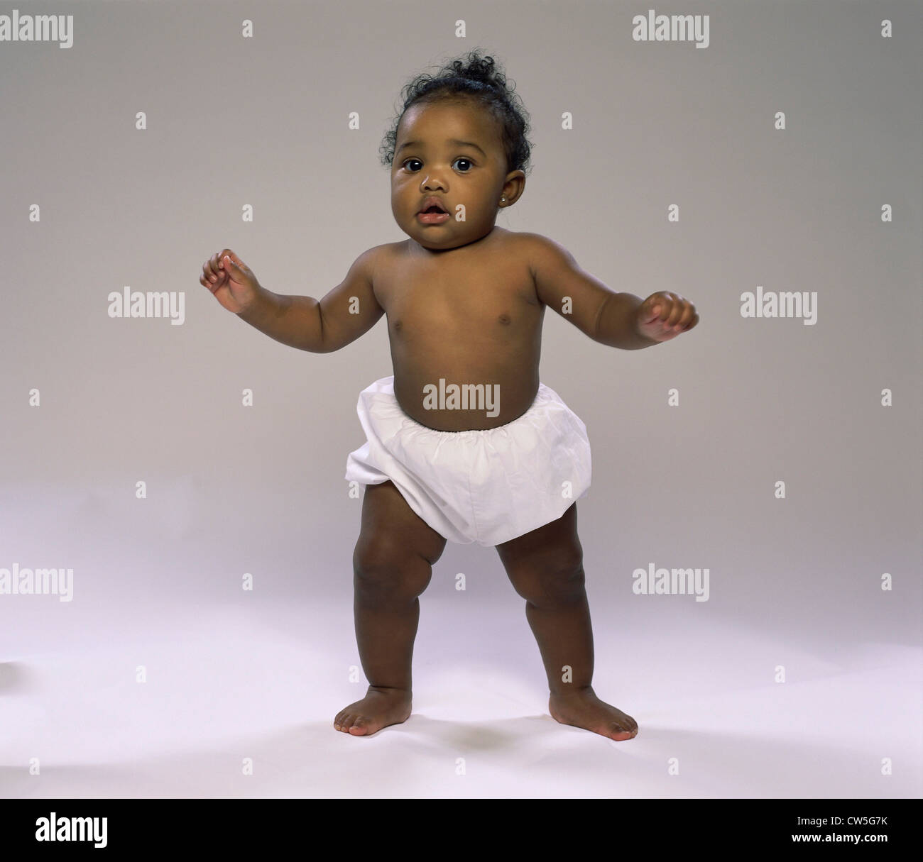 Baby trying to walk Stock Photo - Alamy