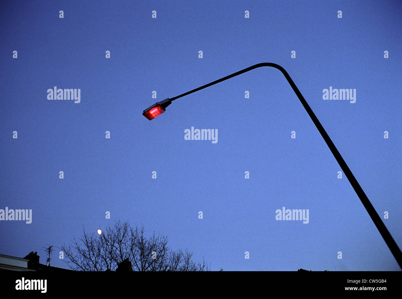 A street lamp with red light shortly after switching Stock Photo - Alamy