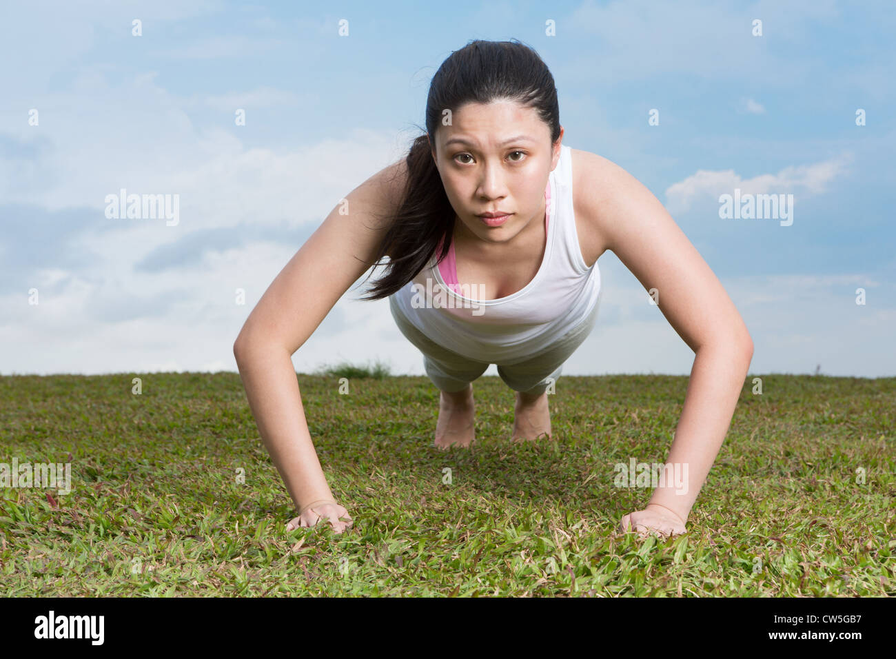 Fit Chinese woman doing push-ups at the park Stock Photo - Alamy