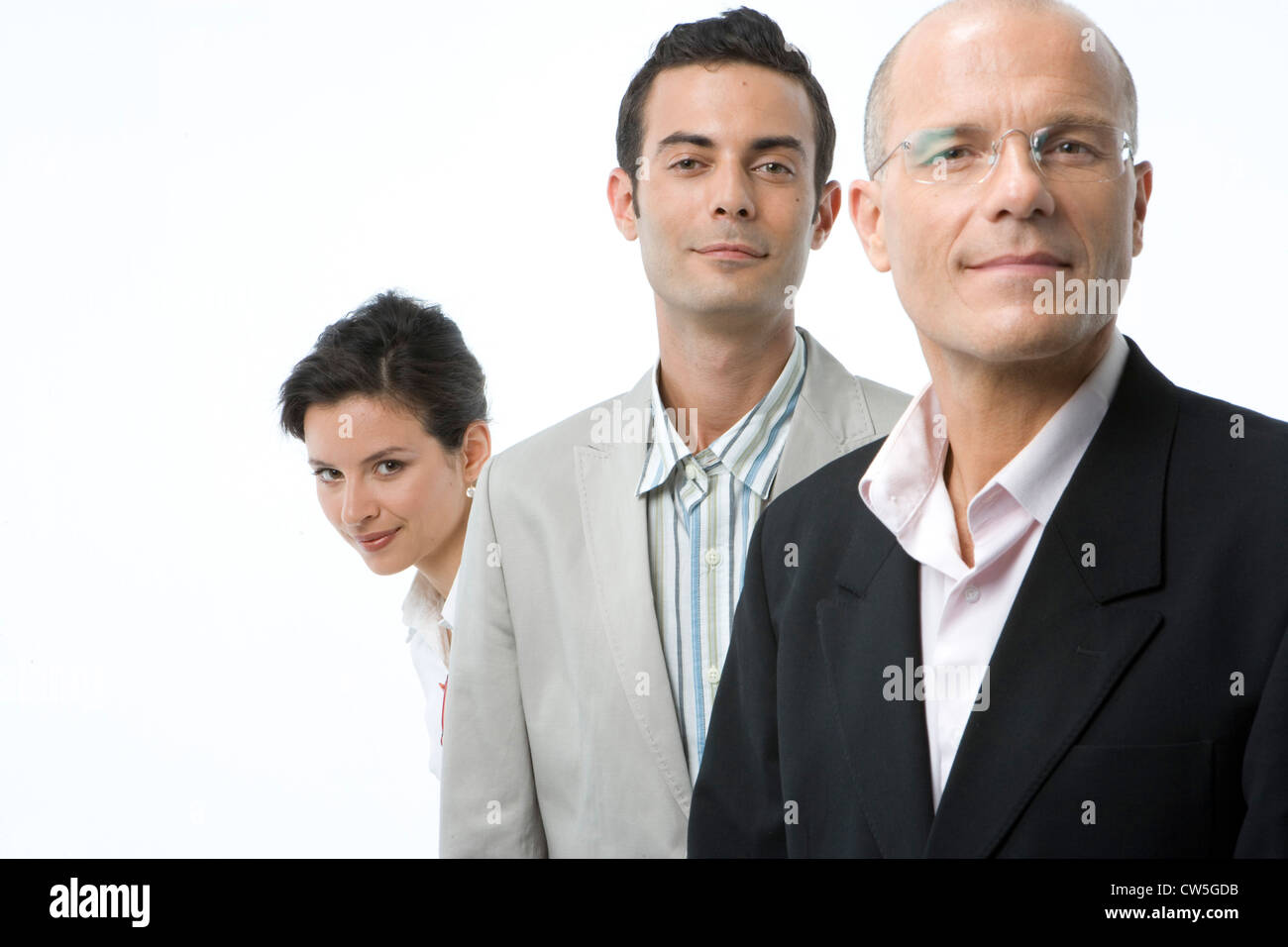 Businessmen with a businesswoman peeking from behind them Stock Photo ...