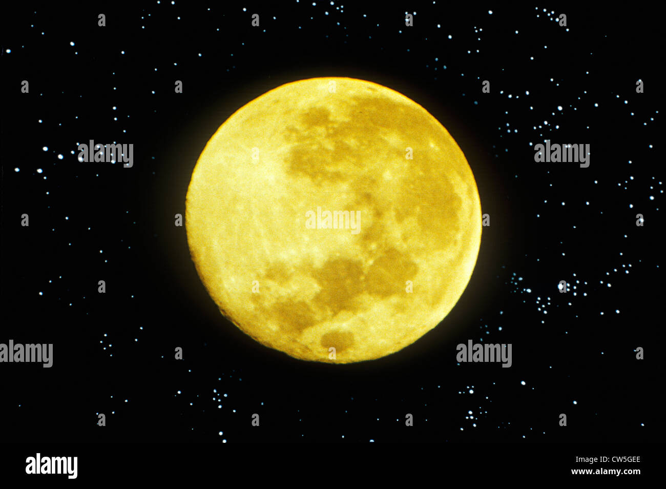 A close-up of a yellowish full moon in a starry sky Stock Photo - Alamy