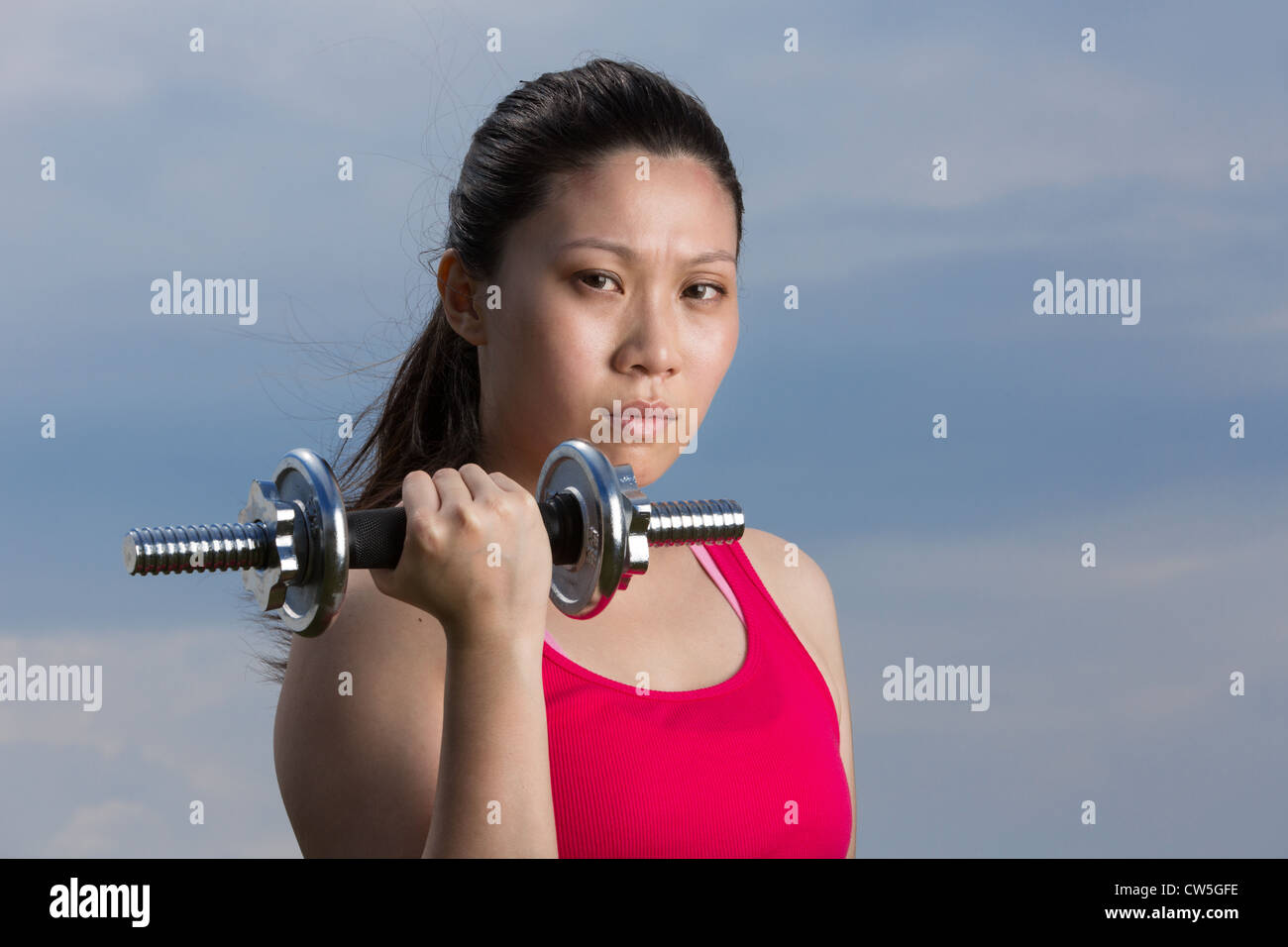 Chinese woman exercising with dumbbells Stock Photo - Alamy