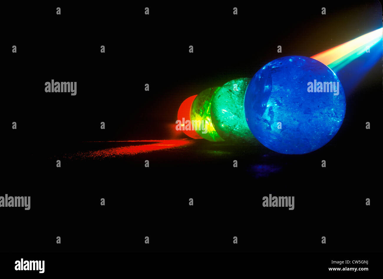 Several multi-colored spheres appearing as planets with laser lights ...
