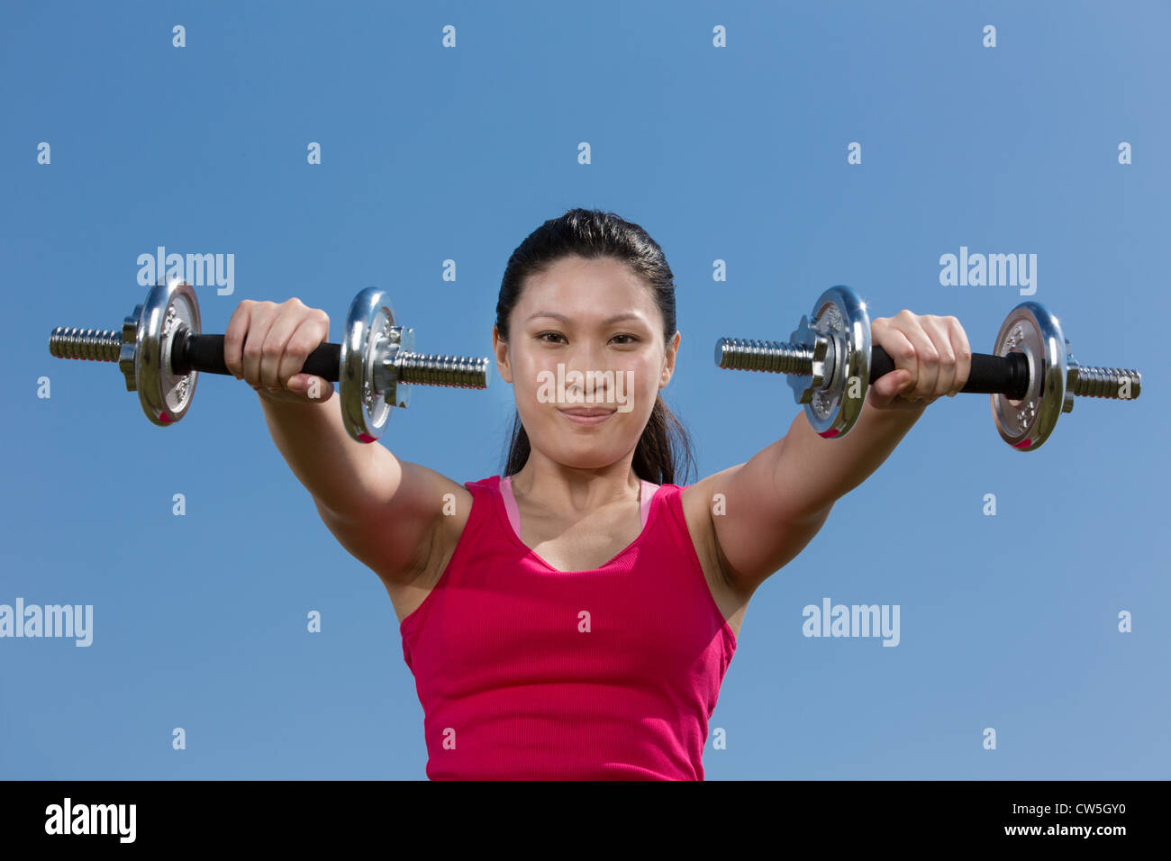 Chinese woman exercising with dumbbells Stock Photo - Alamy