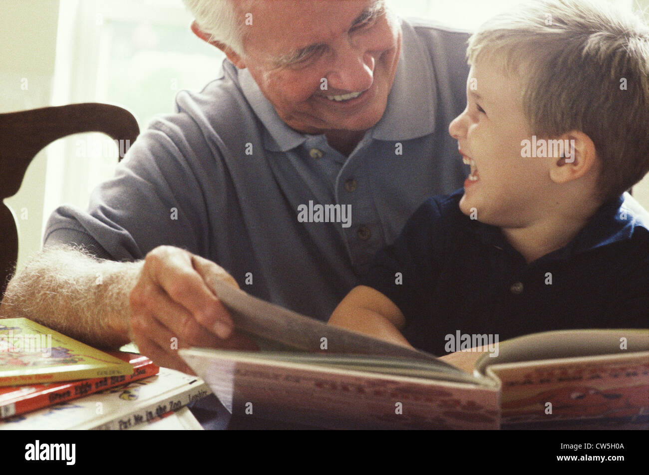 Grandson grandfather book chair hi-res stock photography and images - Alamy